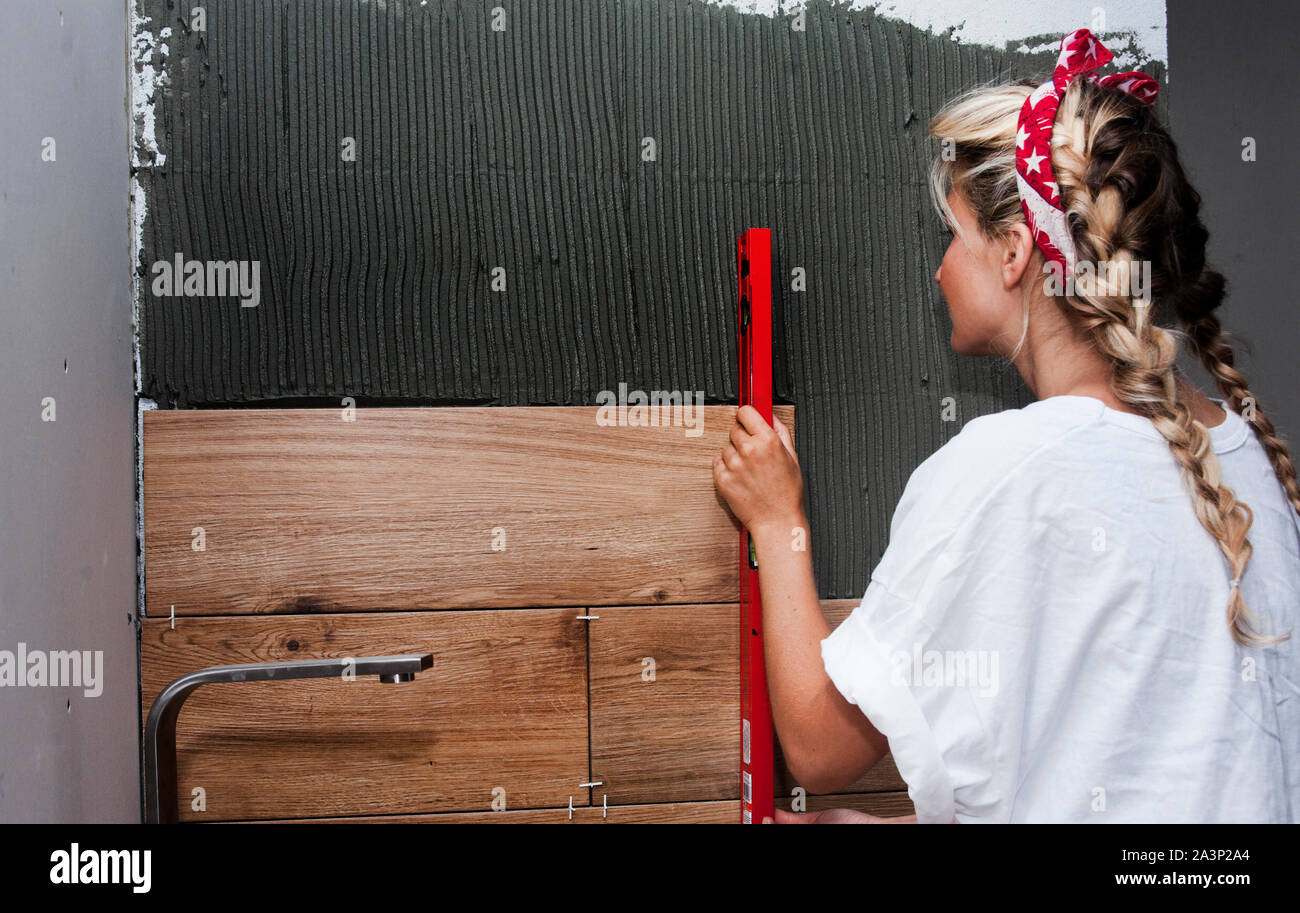 Woman tiling floor hi-res stock photography and images - Alamy