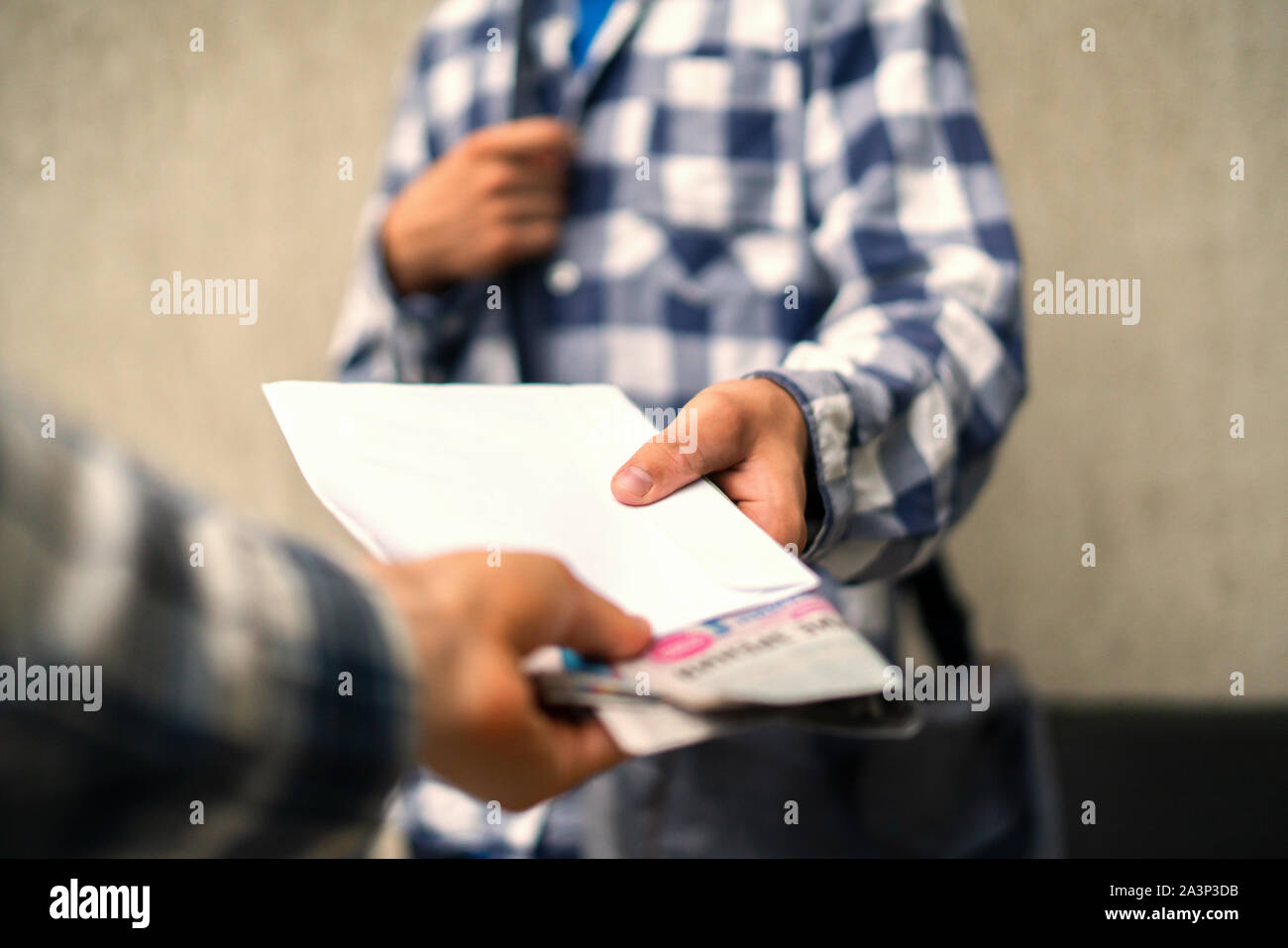 young postman deliver the newspaper envelope and documents at homes ...