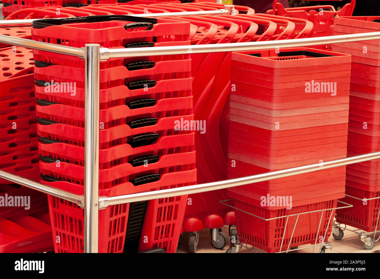 Many red baskets in the supermarket. Shopping basket. Retail business ...