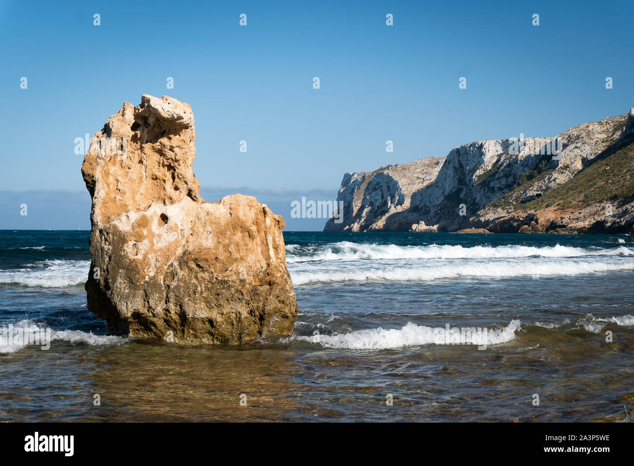 Las Rotas rocky beach in Denia, Spain, waves crushing on the cliffs ...