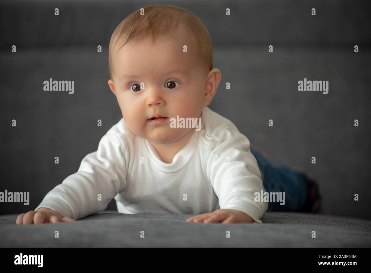 Cute little baby girl looking fascinated Stock Photo - Alamy