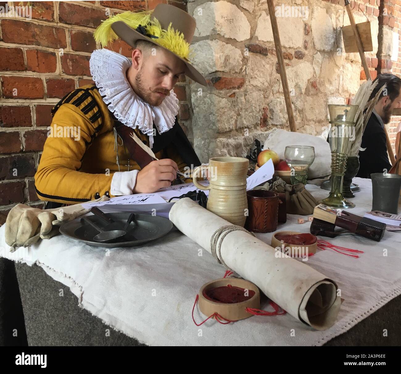 a man in a historical dress signs manuscripts with a quill Stock Photo ...