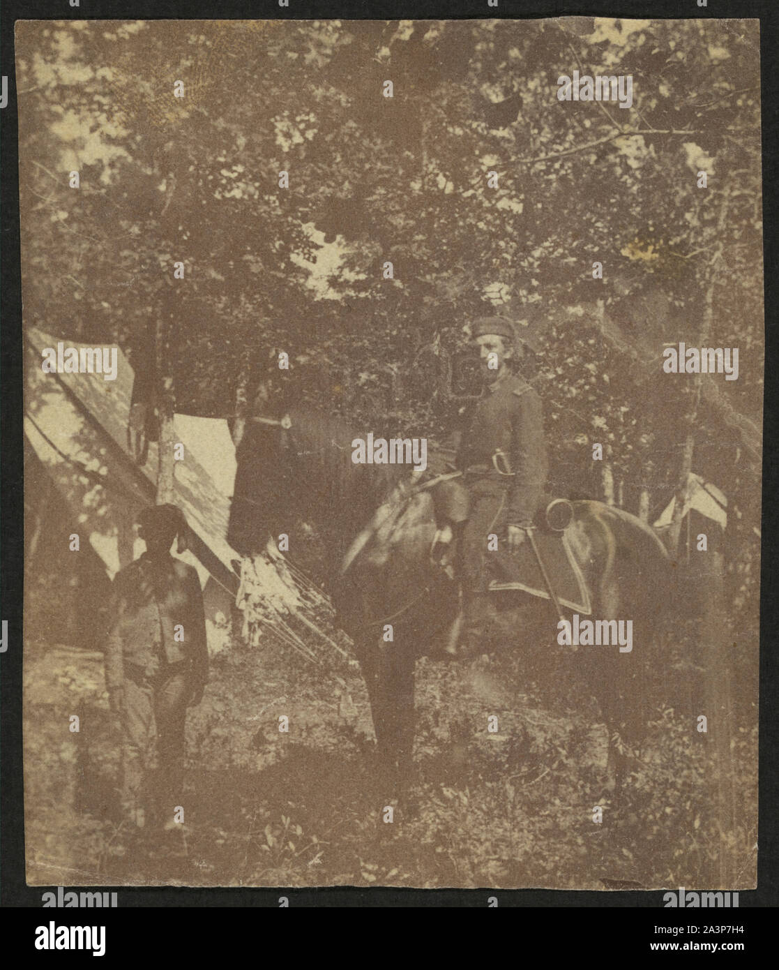 Soldier on horseback with African American servant Stock Photo - Alamy