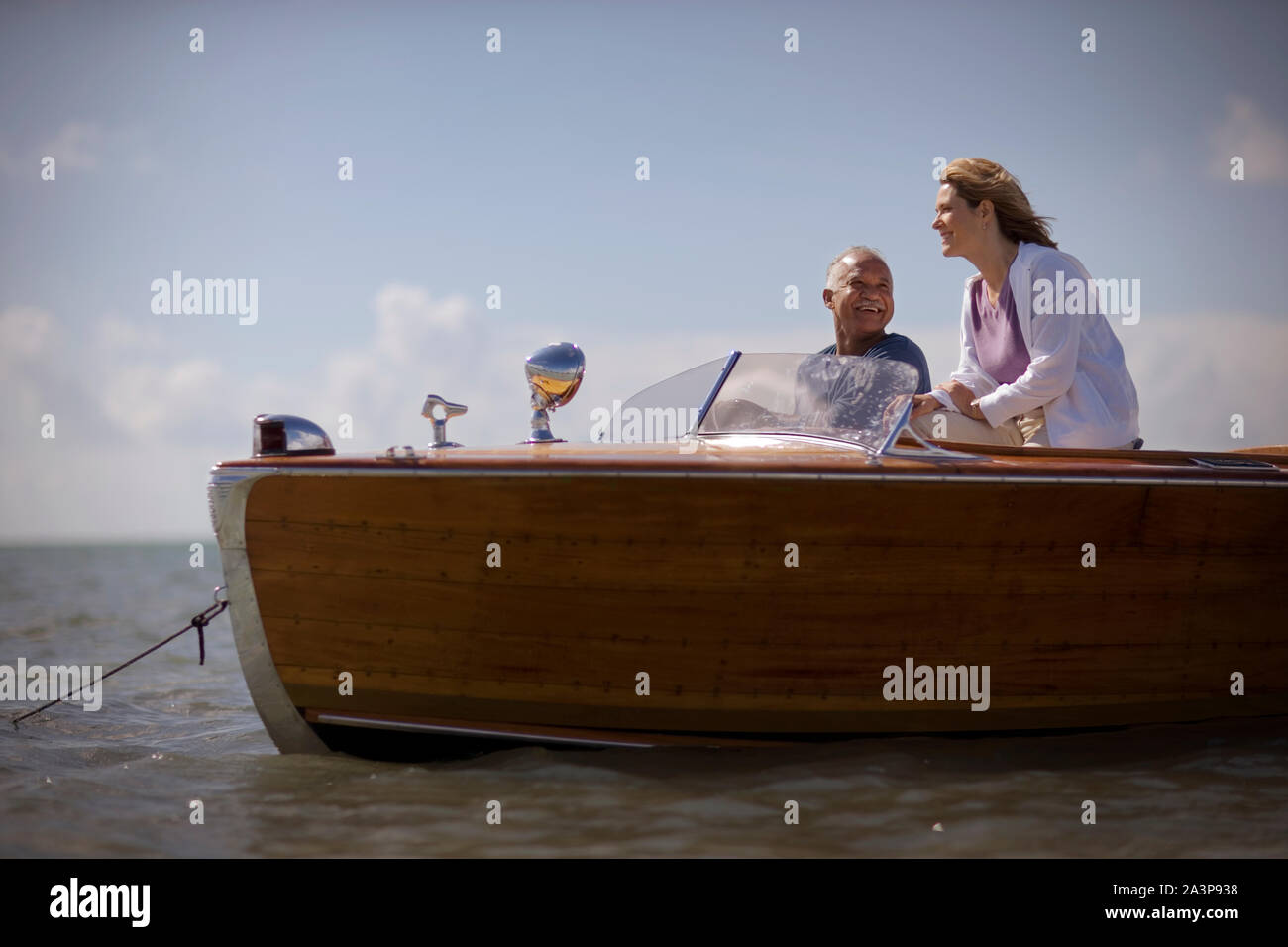 Happy mid-adult couple on a boat together on the ocean Stock Photo - Alamy
