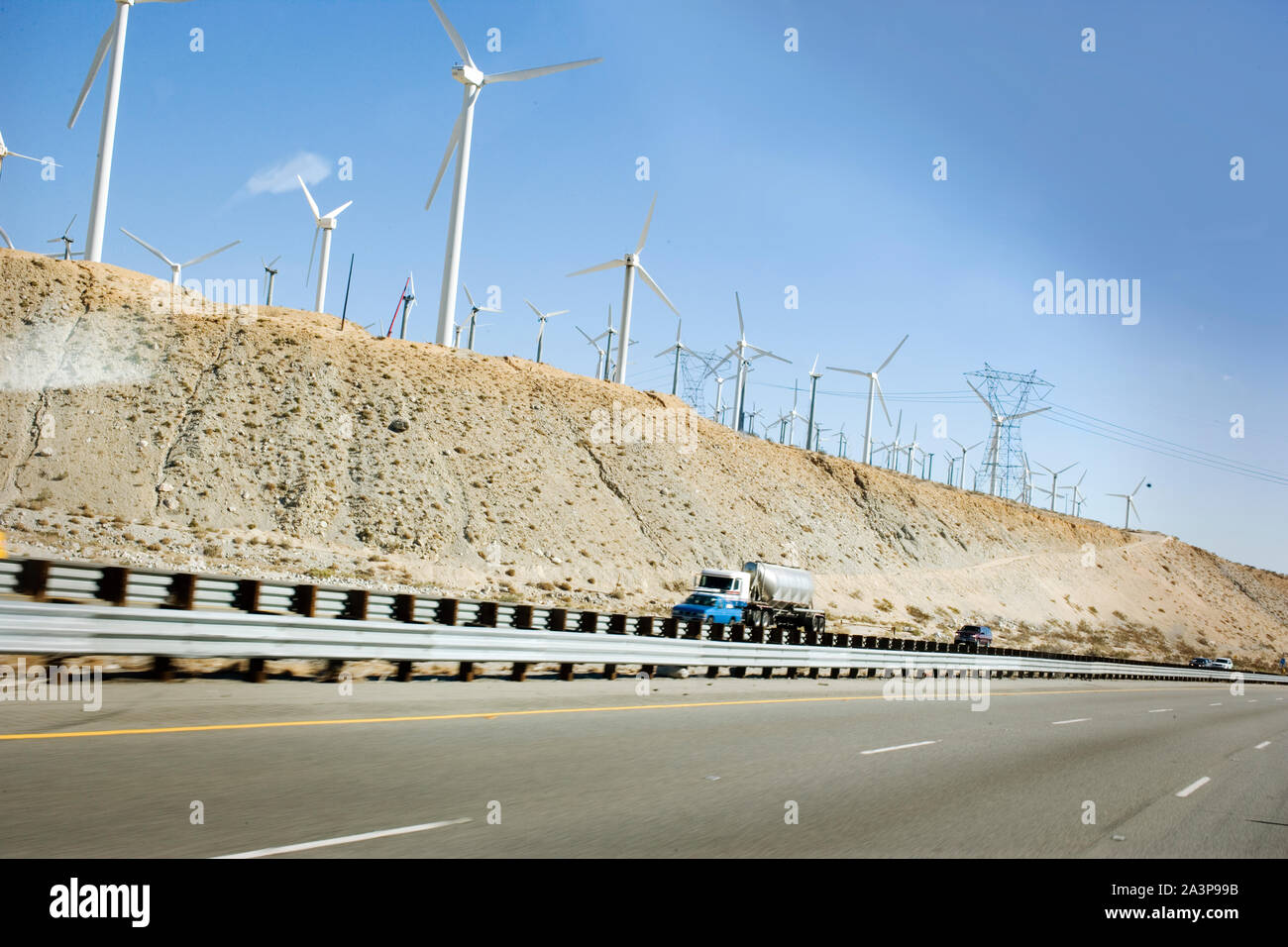 Group of wind turbines alongside a highway Stock Photo - Alamy