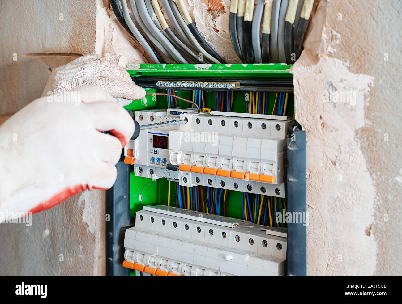The electrician is installing the fuses in the switch box Stock Photo ...