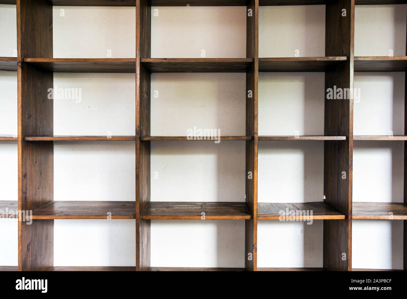 empty wooden cupboard storage near white wall, modern interior closeup ...
