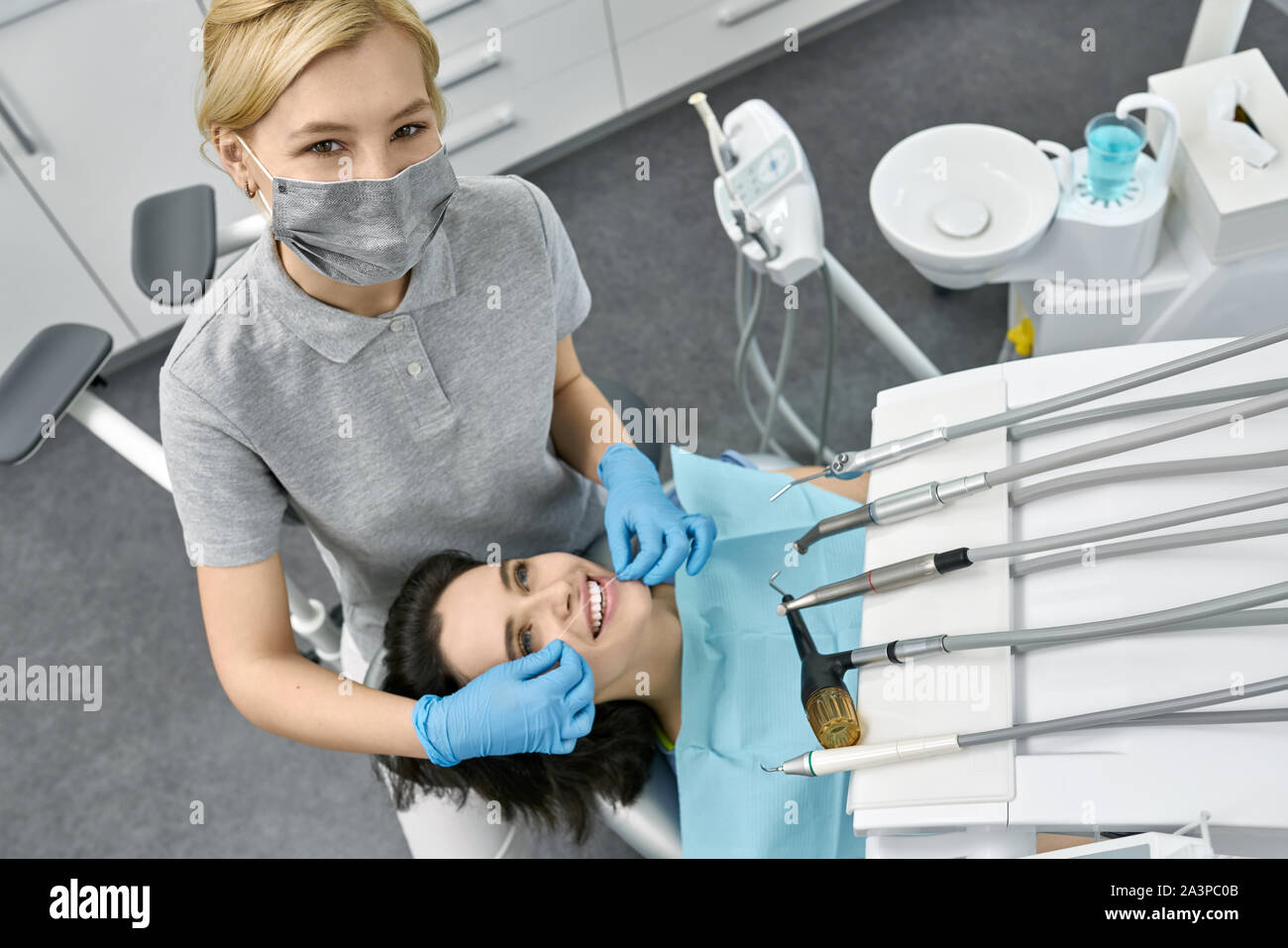 Pretty woman's teeth cleaning in dental clinic Stock Photo - Alamy