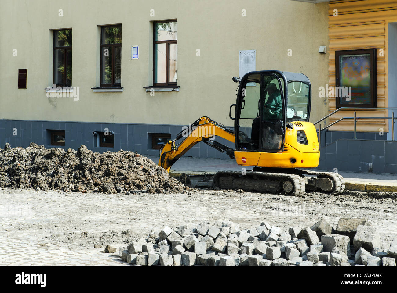 Tractor digger is digging a trench for the installation of water pipes ...