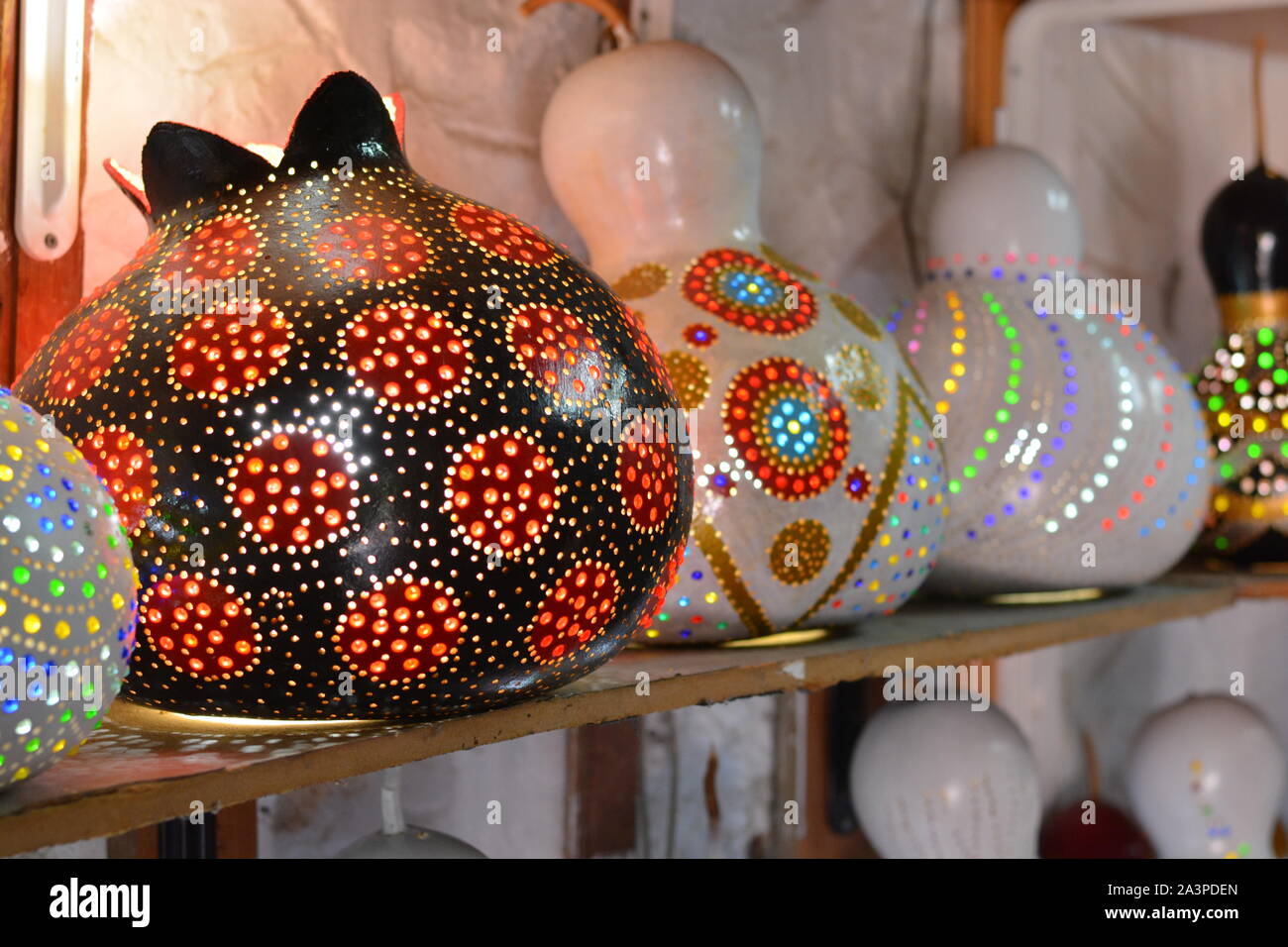 Brightly coloured, handcrafted toys and lamps carved from gourds sold ...