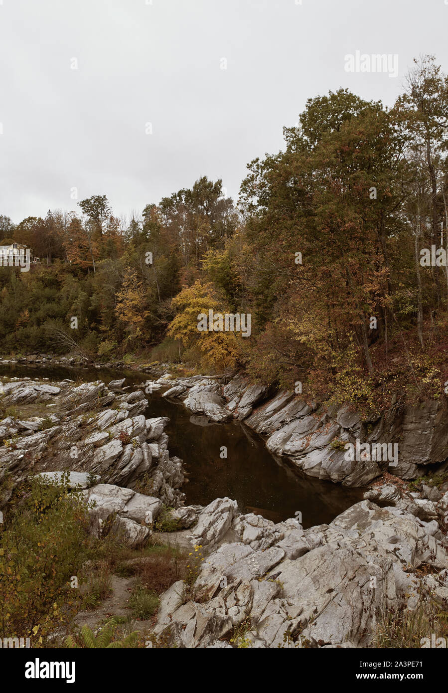 Fall Foliage surrounding stream in the New England town of Quechee ...
