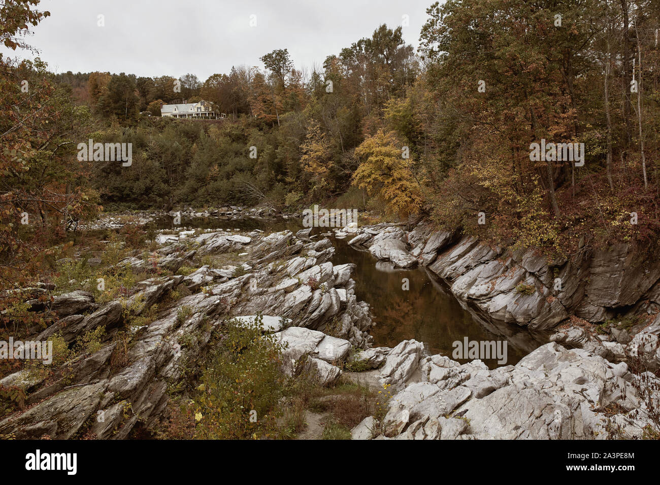 Fall Foliage surrounding stream in the New England town of Quechee ...