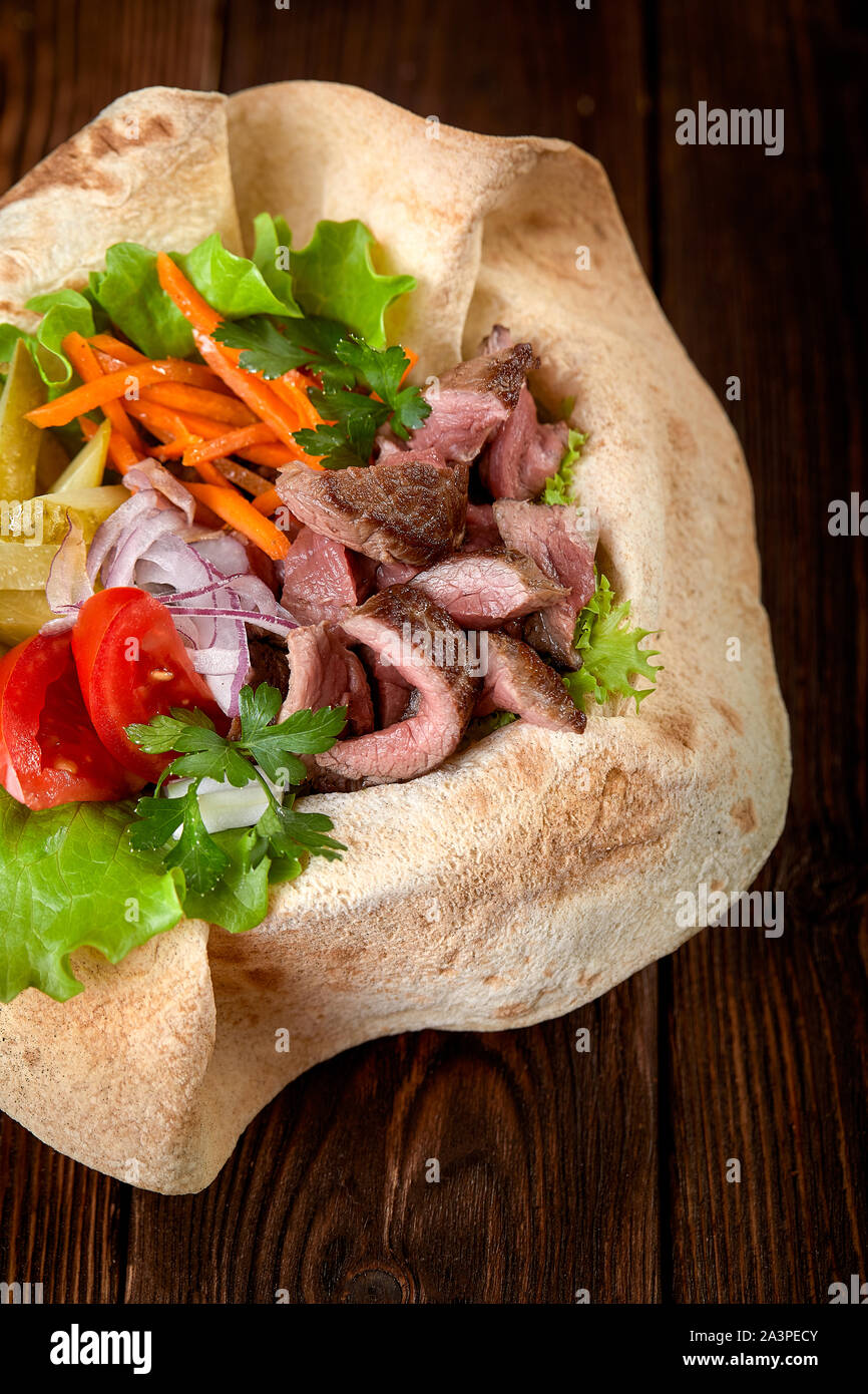 Meat salad with beef and fresh vegetables and lettuce in a plate-baked ...