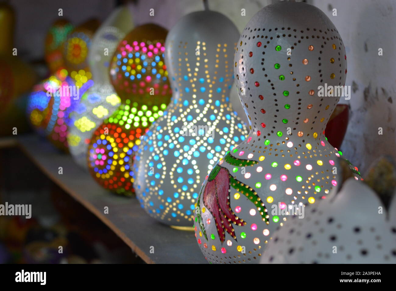 Brightly coloured, handcrafted toys and lamps carved from gourds sold ...
