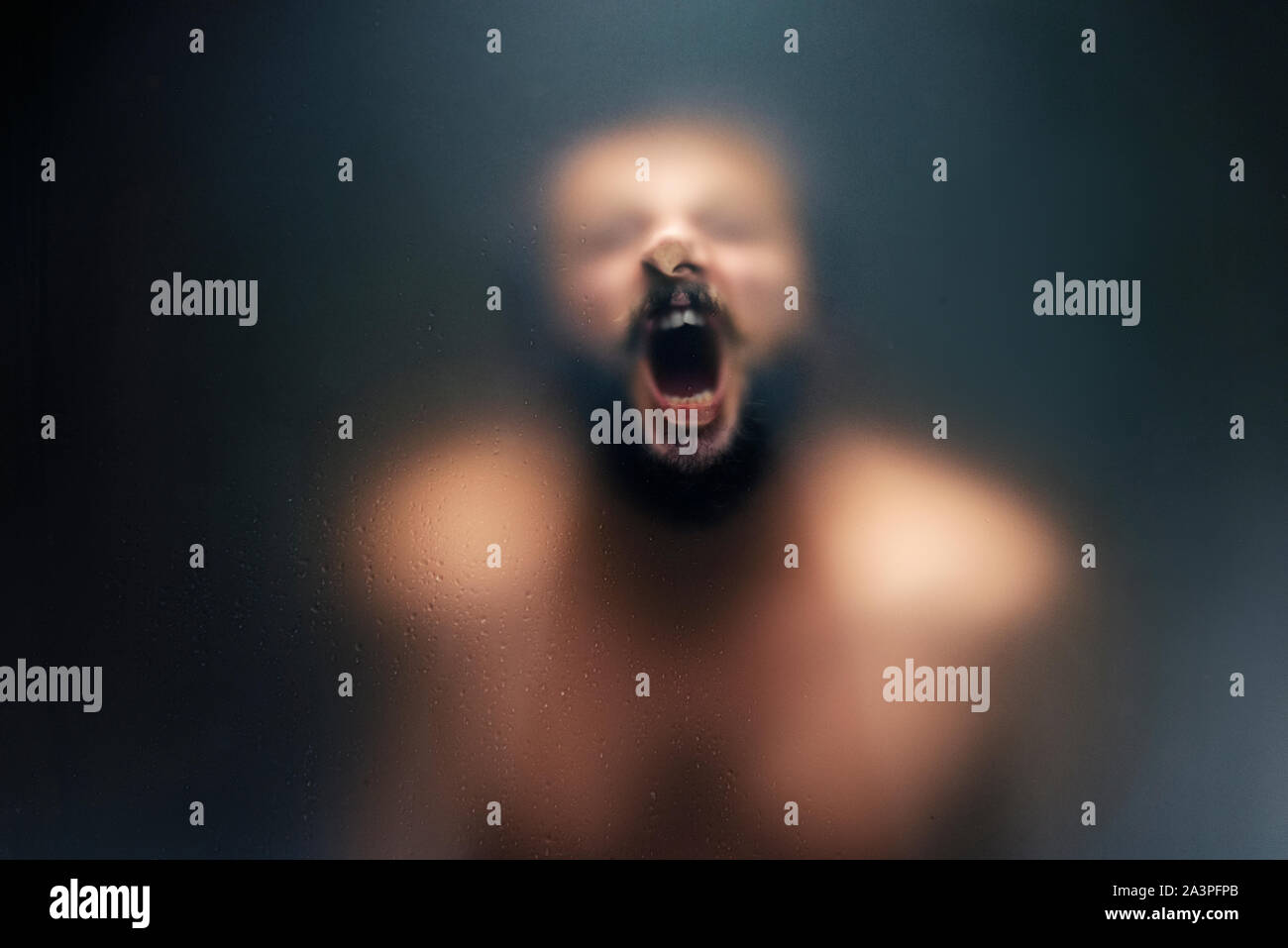 Creepy man screaming behind the frosted glass Stock Photo - Alamy