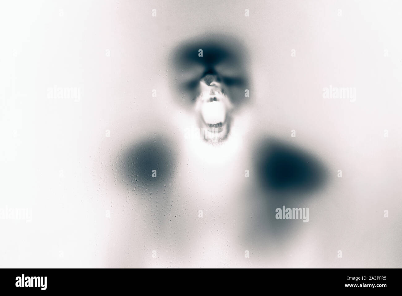 Inversed color version of Creepy man screaming behind the frosted glass ...