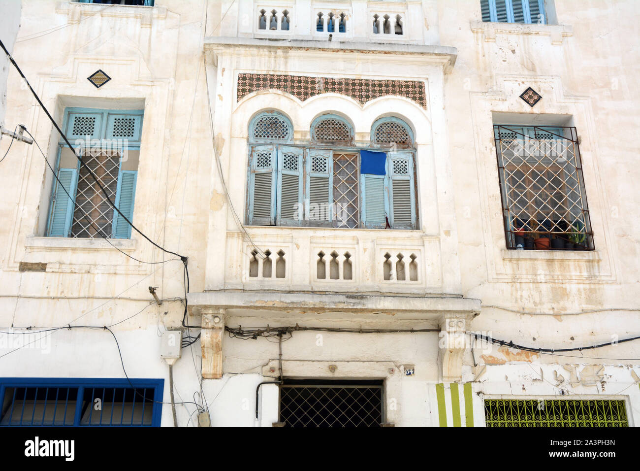 The exterior facade of an old traditional house (with windows, shutters ...