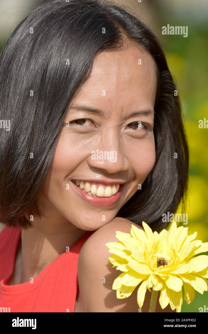 Portrait Of A Youthful Asian Person With A Flower Stock Photo - Alamy