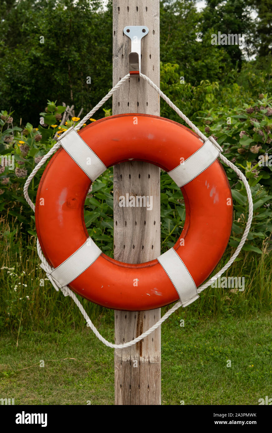 Single Orange Life Preserver on Post along shore of lake Stock Photo ...