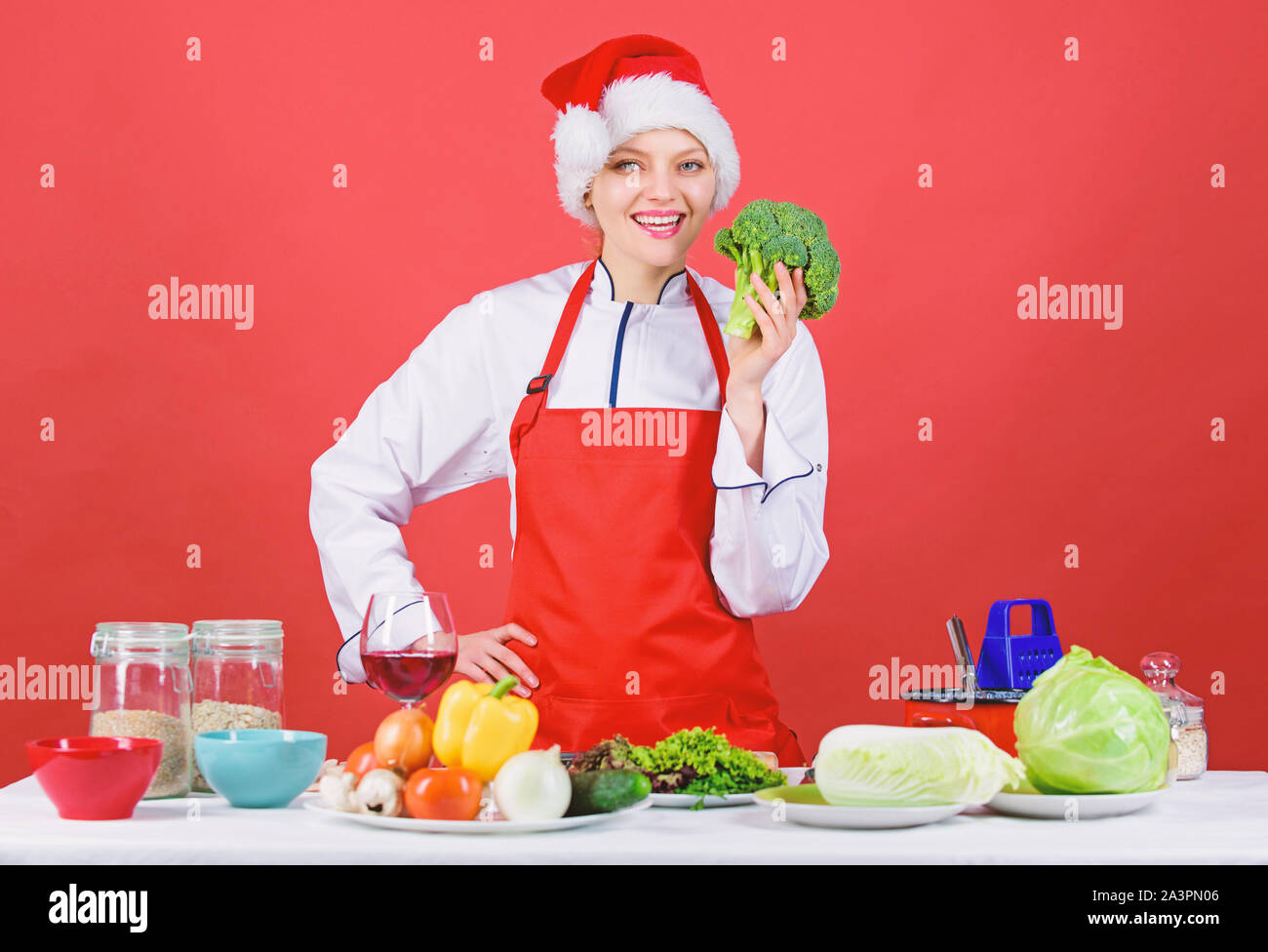 Woman chef cooking christmas dinner wear santa hat. Festive menu ...