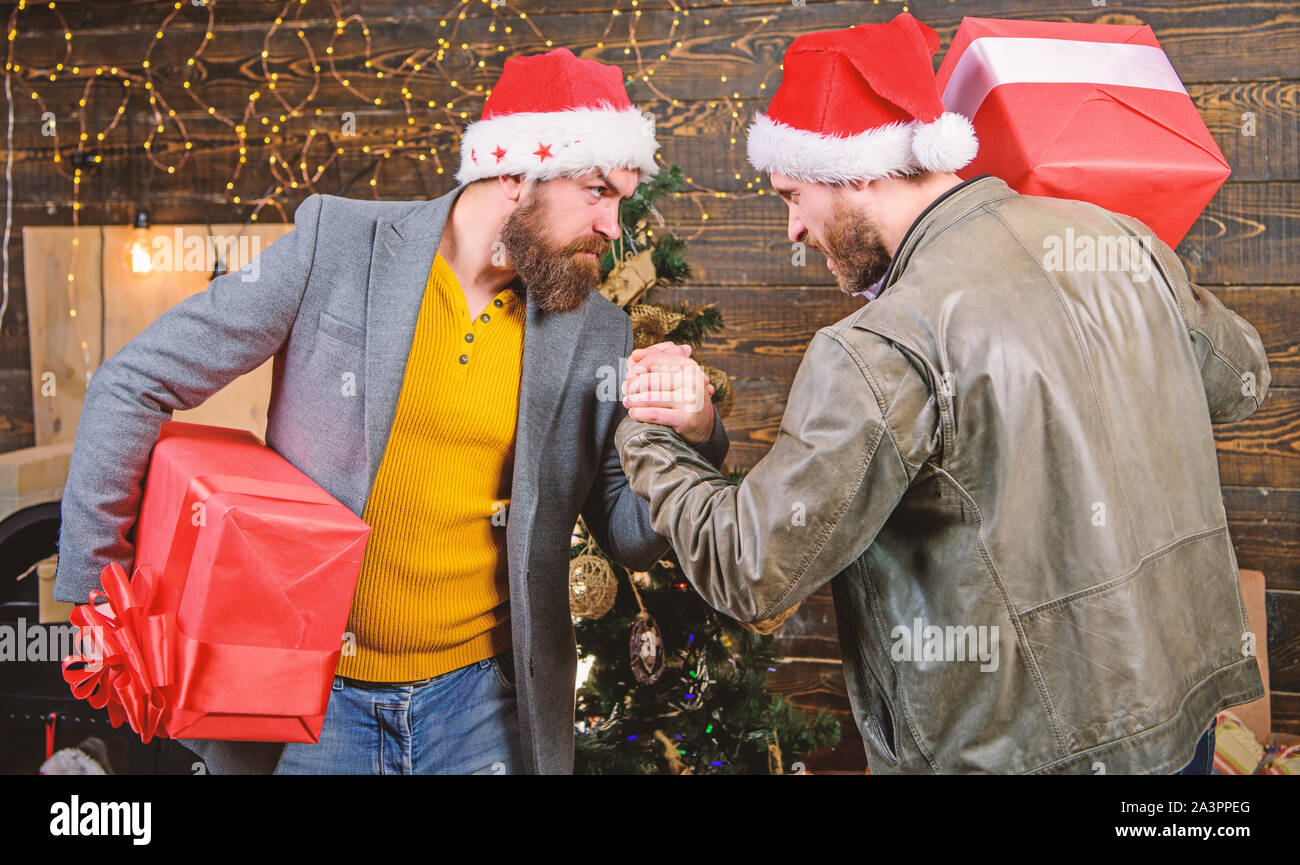 Get ready for christmas. Men wear santa hat hold gift boxes. Bearded ...