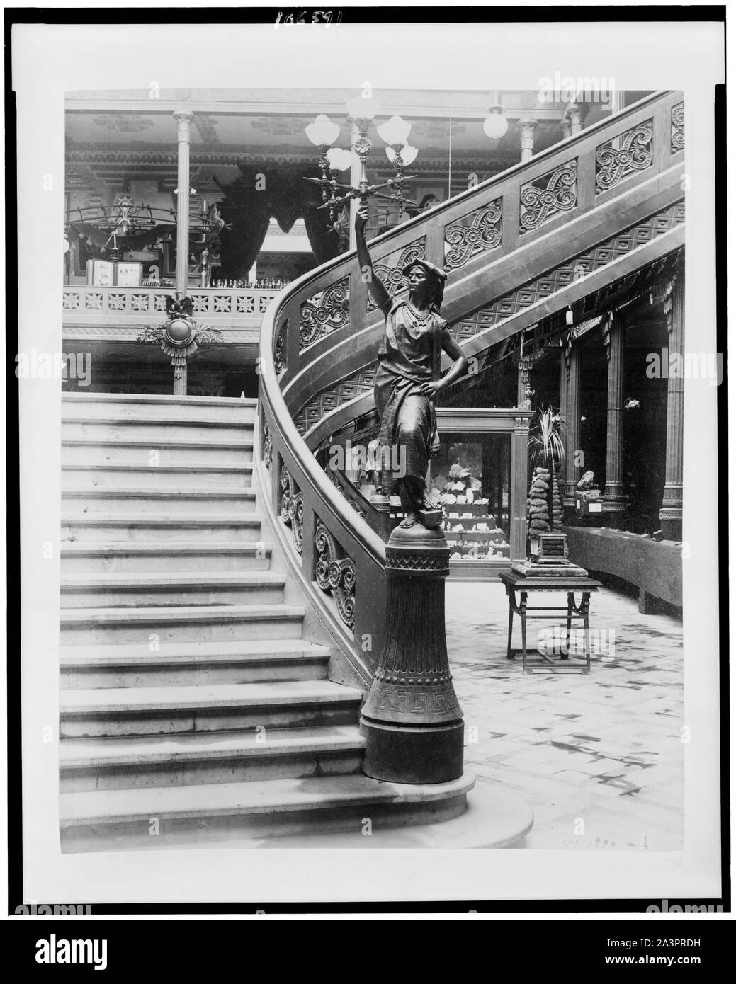 Stairway with statue of woman holding light fixture (lampadaire) in the ...