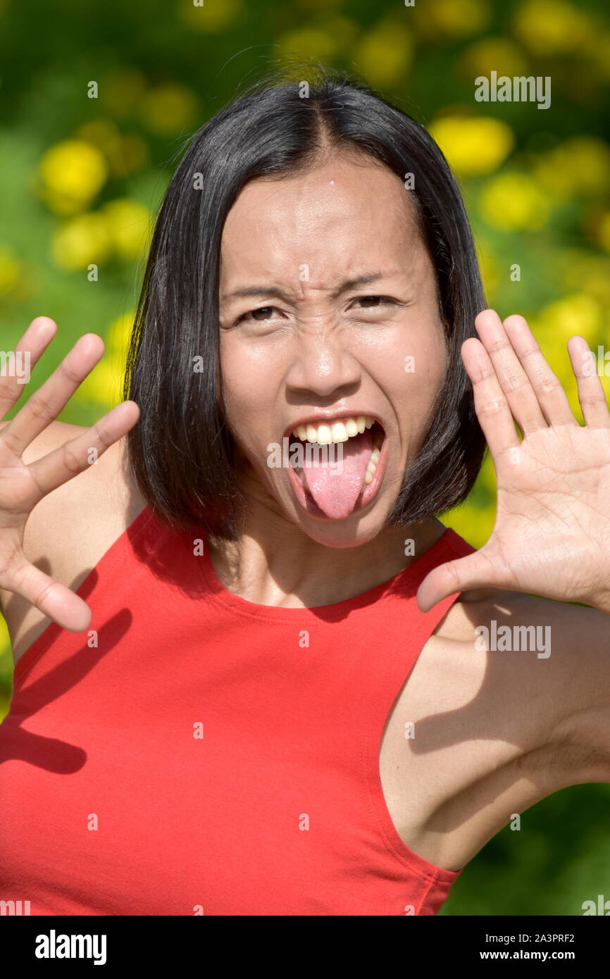 Pretty Asian Adult Female Making Funny Faces Stock Photo - Alamy