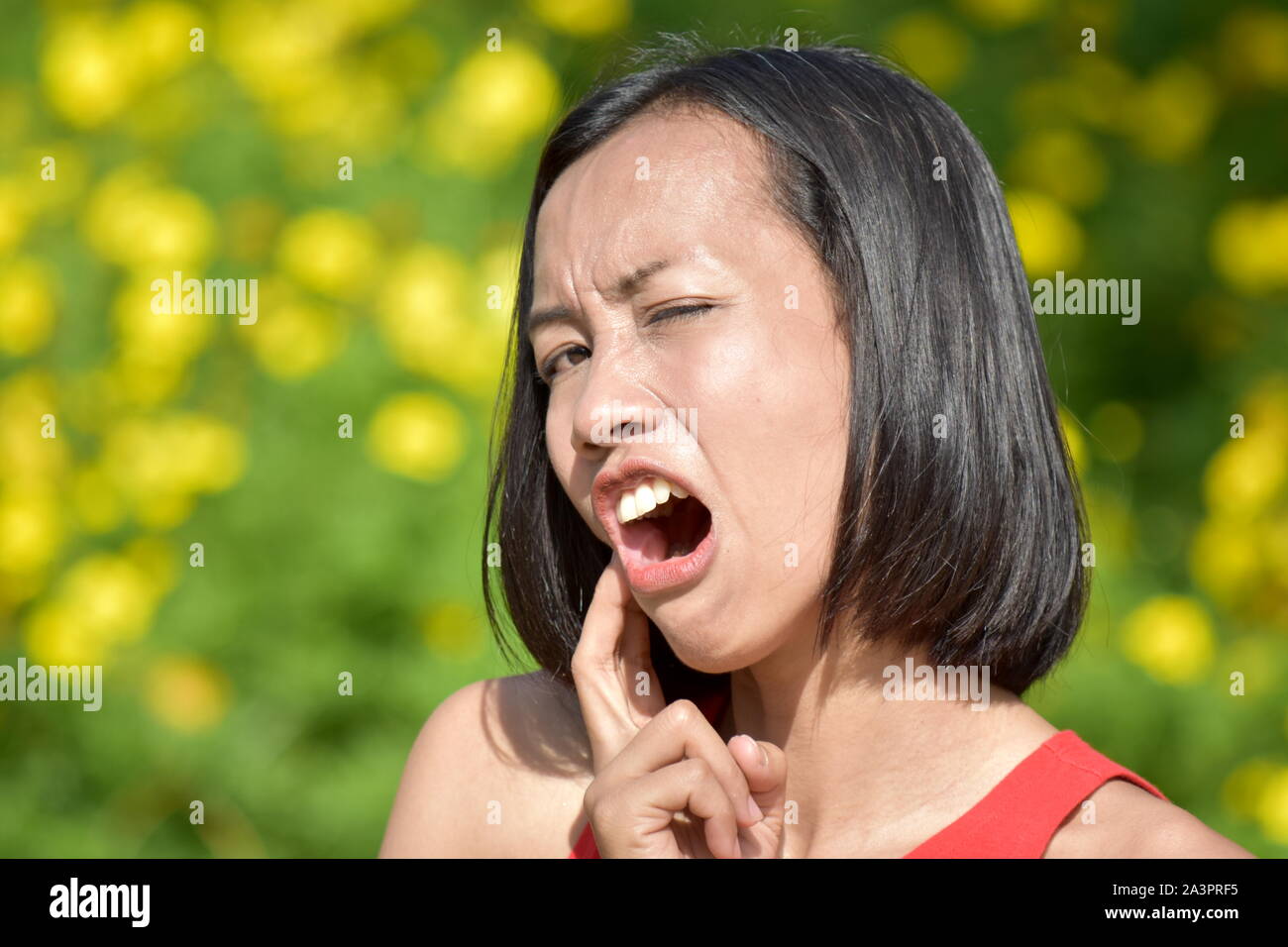 Youthful Filipina Female With Toothache Stock Photo - Alamy