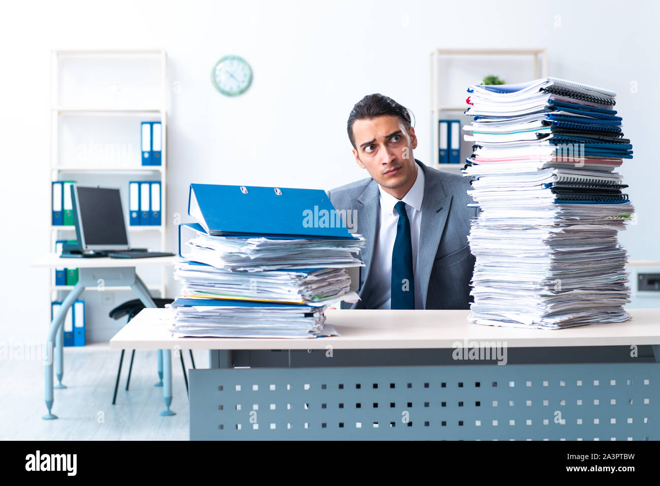 The businessman with heavy paperwork workload Stock Photo - Alamy