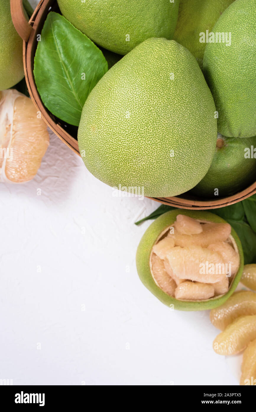 Fresh pomelo, pummelo, grapefruit, shaddock on white cement background ...