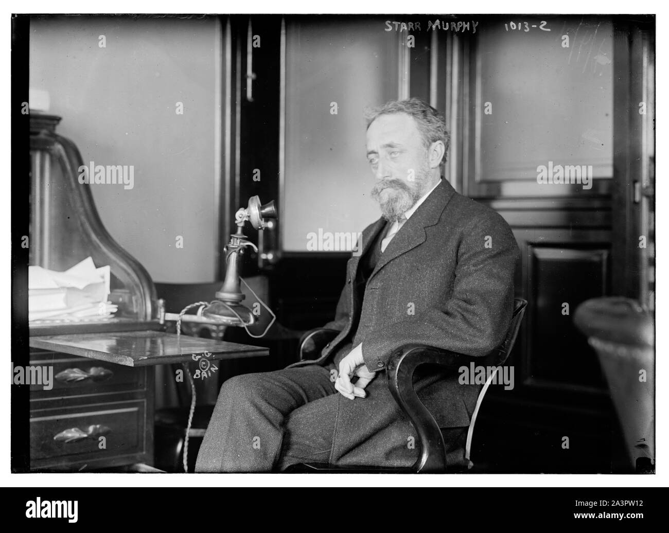 Starr Murphy seated at desk with telephone Stock Photo - Alamy