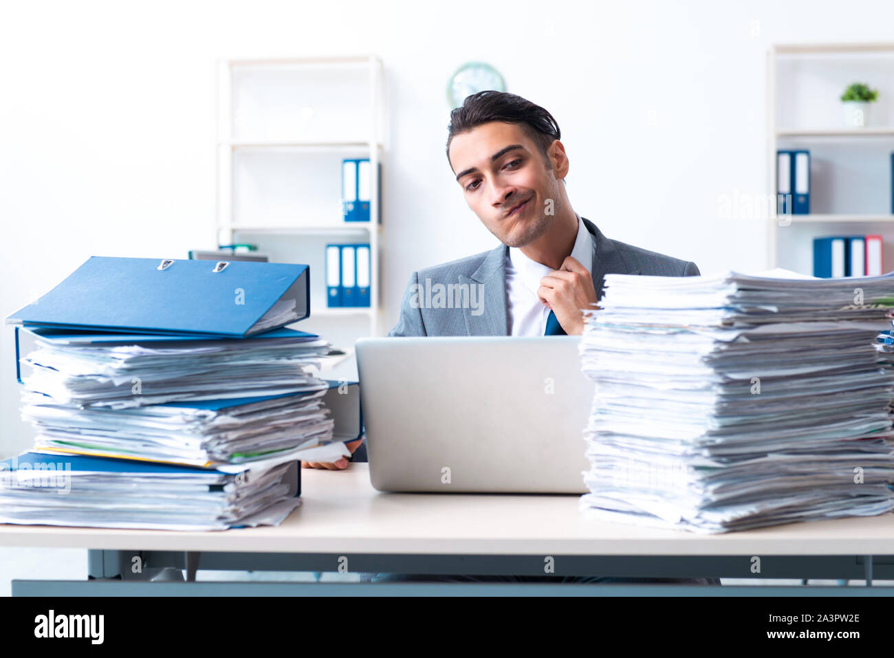 The businessman with heavy paperwork workload Stock Photo - Alamy