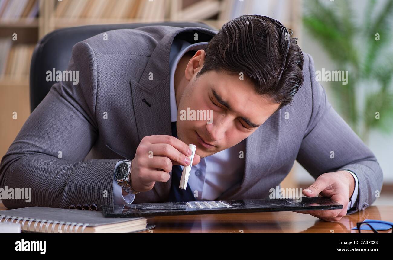 The drug addict businessman in the office Stock Photo - Alamy