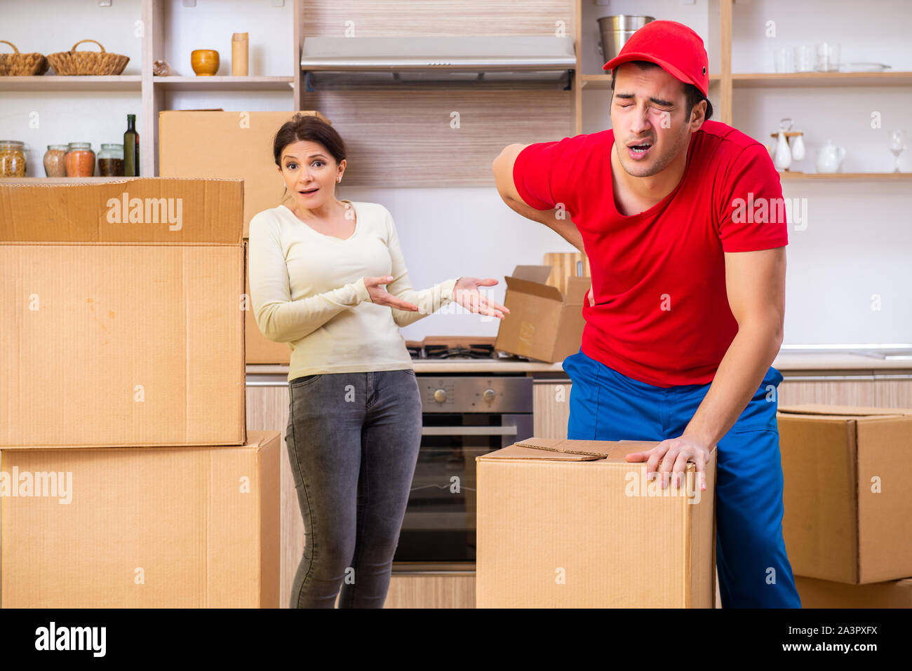 The young male contractor and female customer in moving concept Stock ...