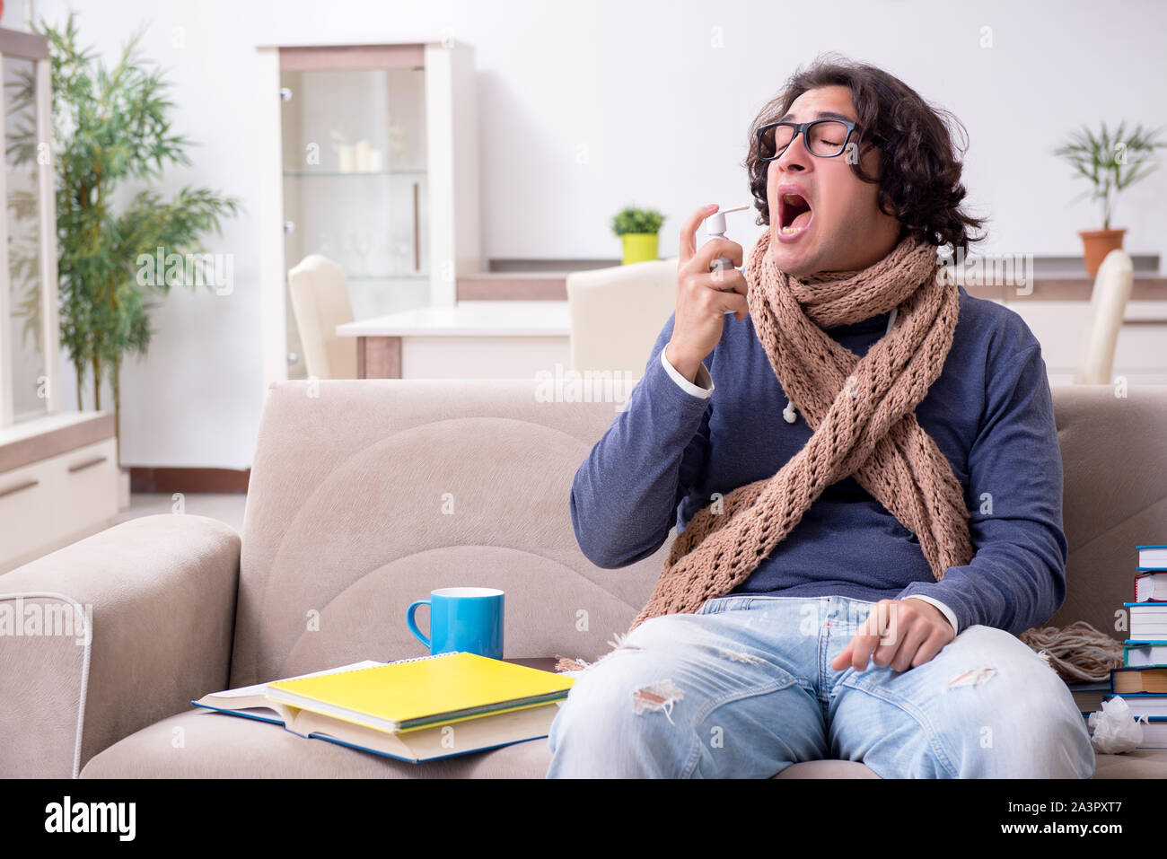 The sick male student suffering at home Stock Photo - Alamy