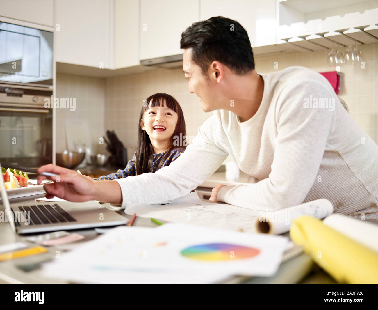 young asian man free lance designer father working at home while taking ...