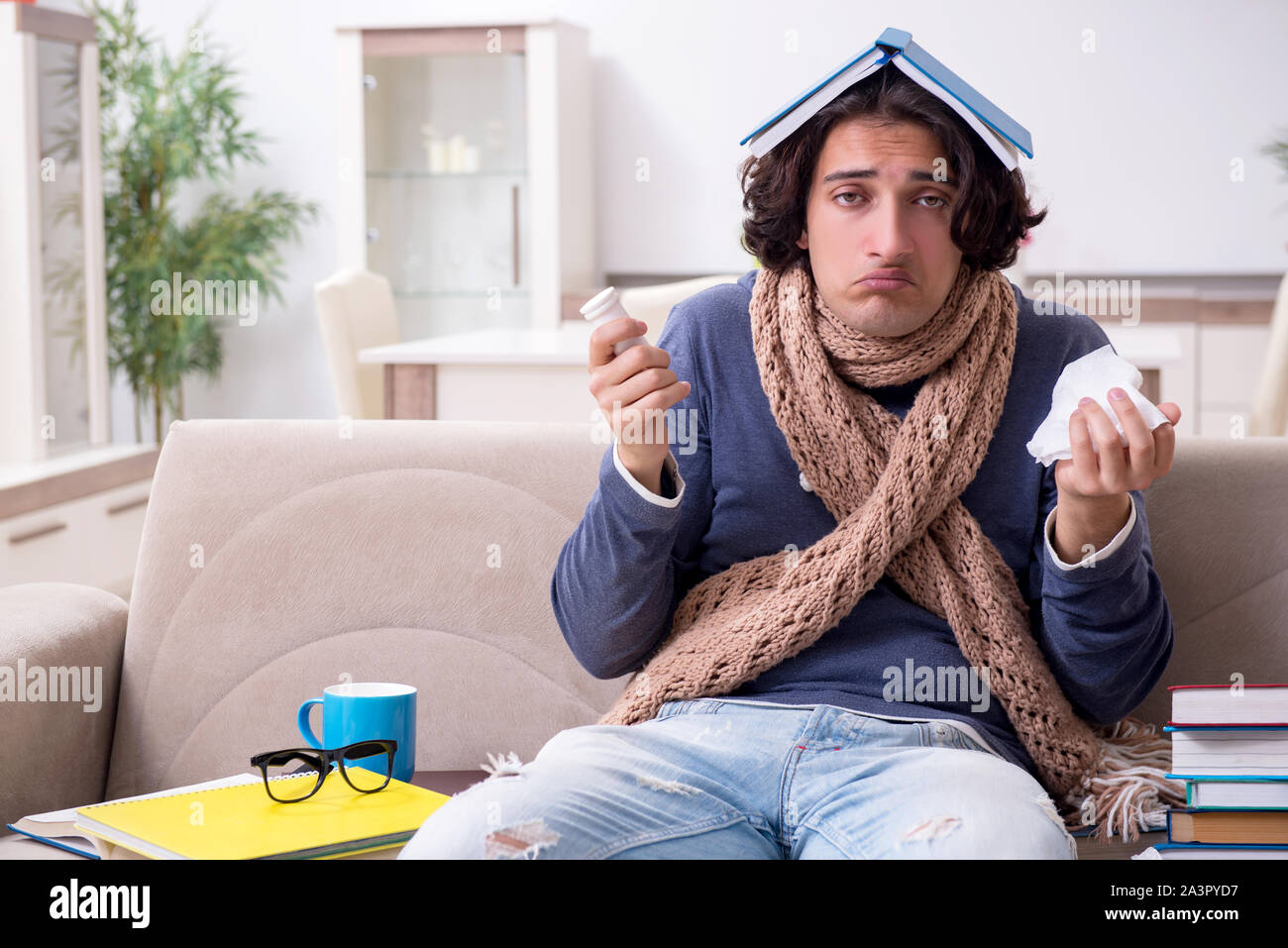 The sick male student suffering at home Stock Photo - Alamy