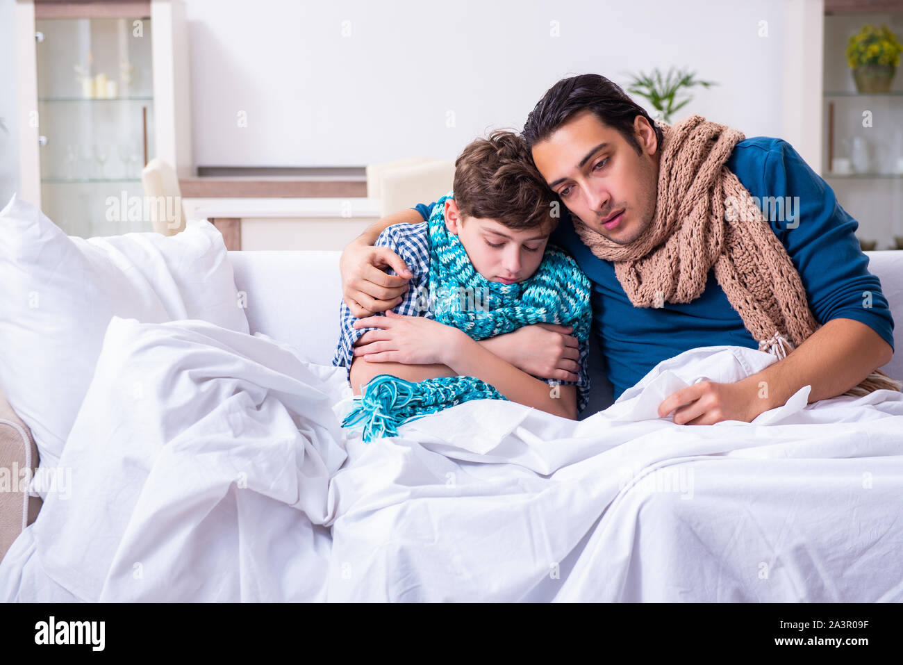 The young father caring for sick son Stock Photo - Alamy