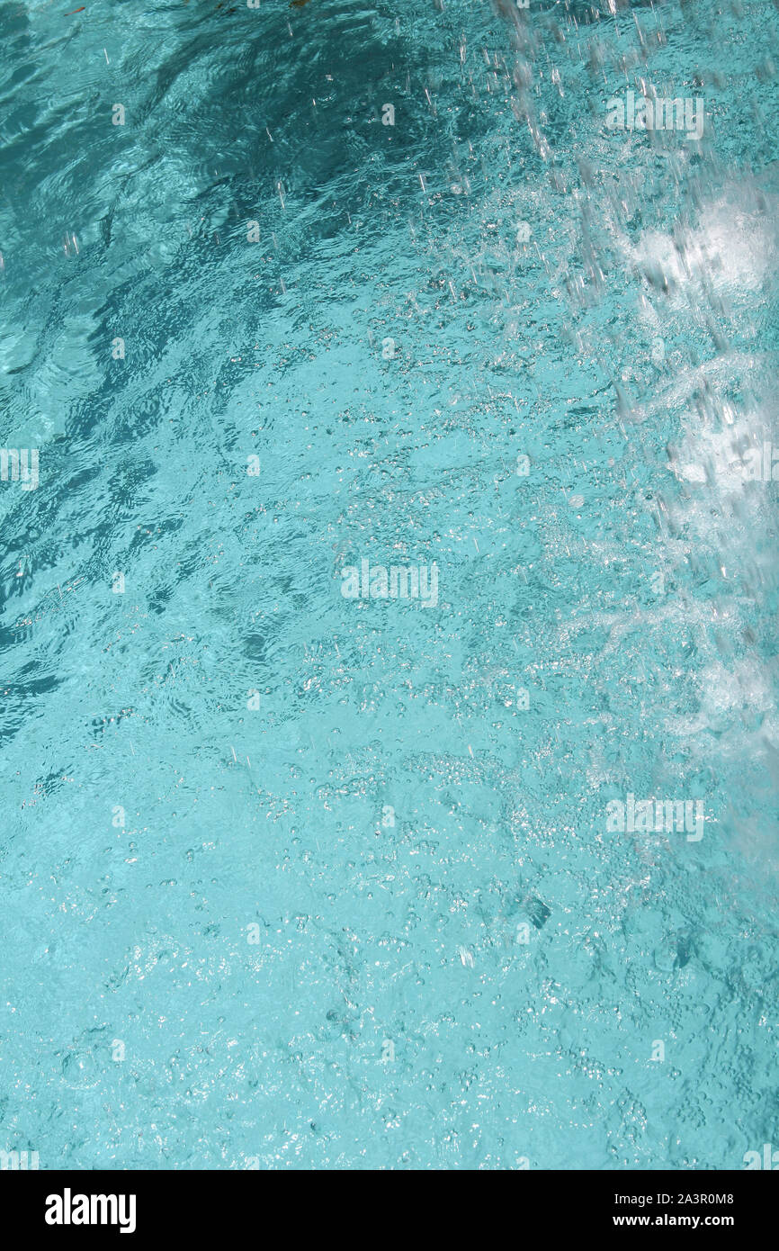 Blue pool water reflecting sun rippled details.surface of blue pool ...