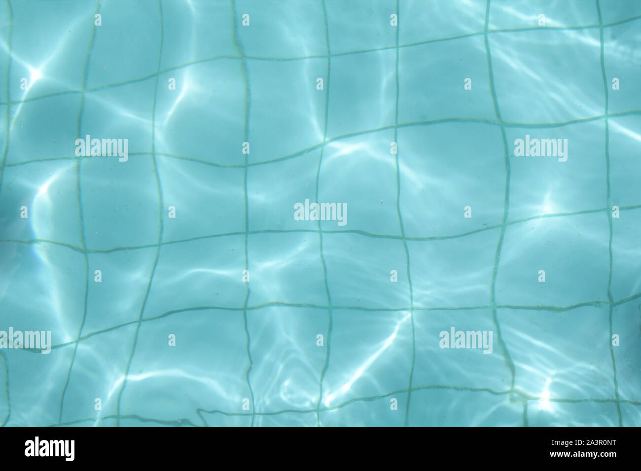 Blue pool water reflecting sun rippled details.surface of blue pool ...