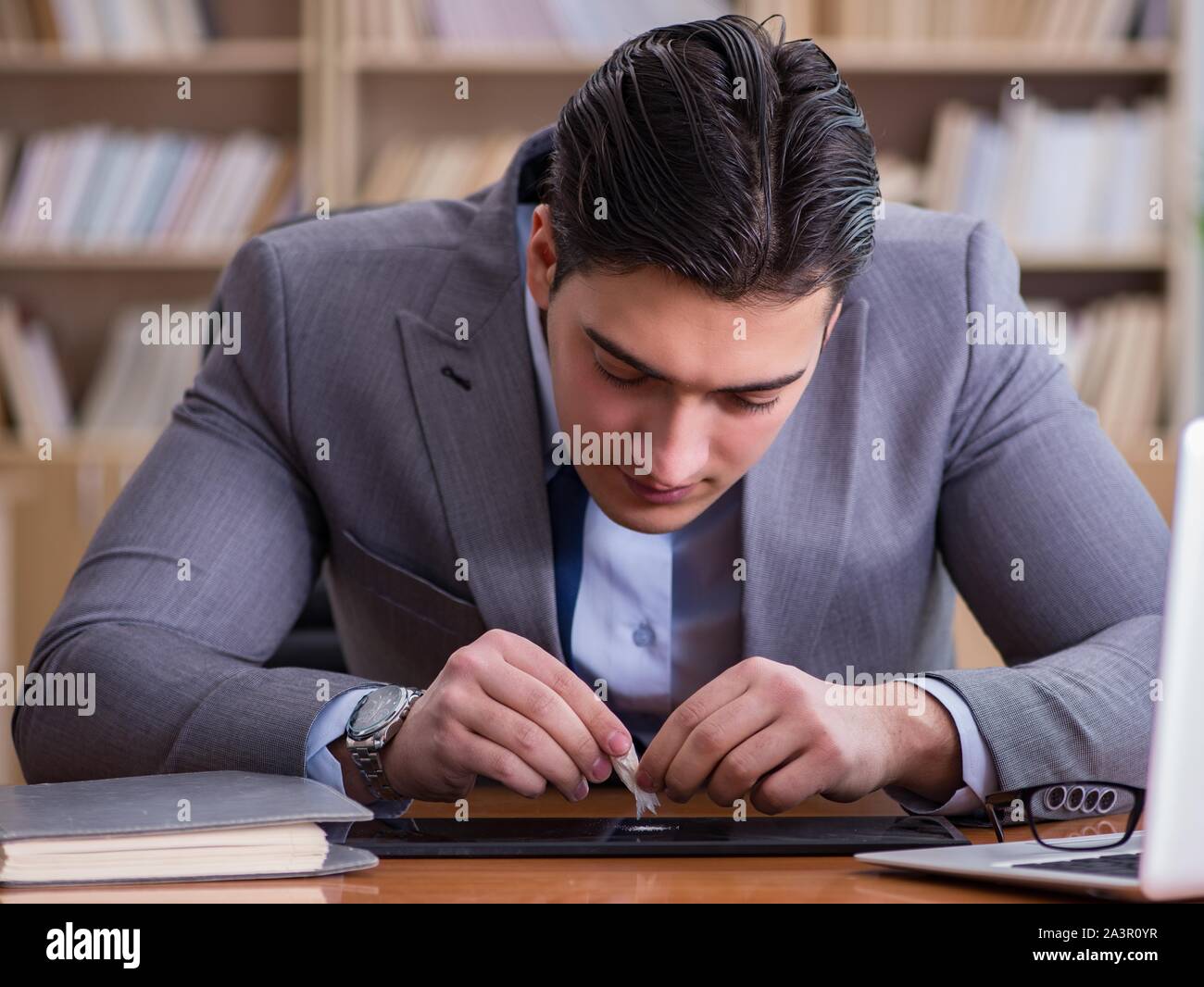 The drug addict businessman in the office Stock Photo - Alamy