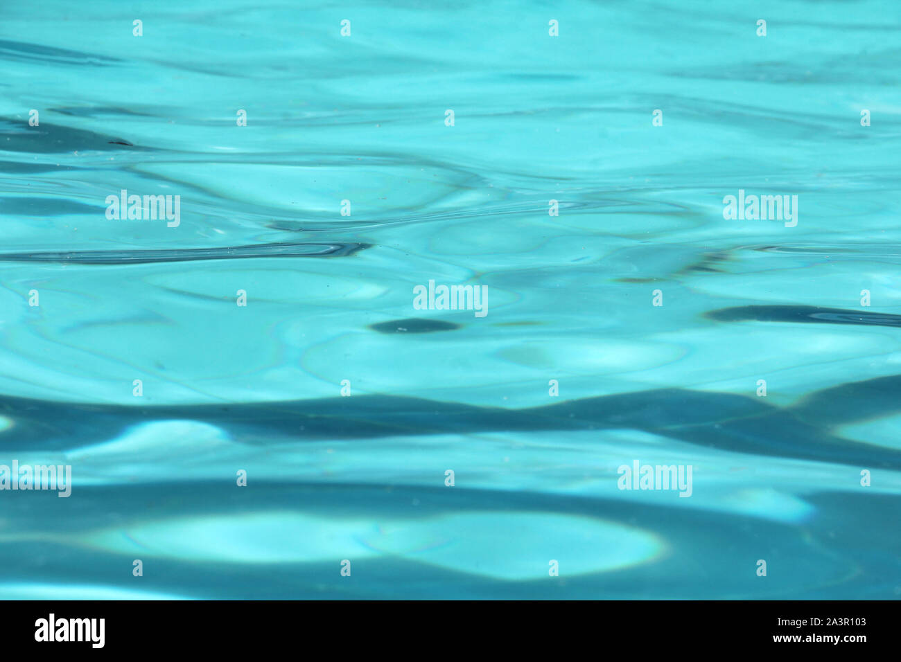 Blue pool water reflecting sun rippled details.surface of blue pool ...