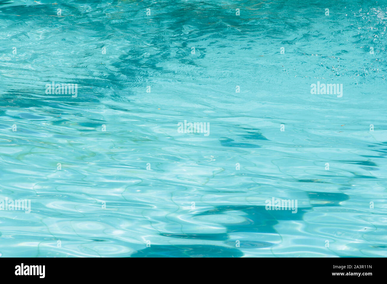 Blue pool water reflecting sun rippled details.surface of blue pool ...