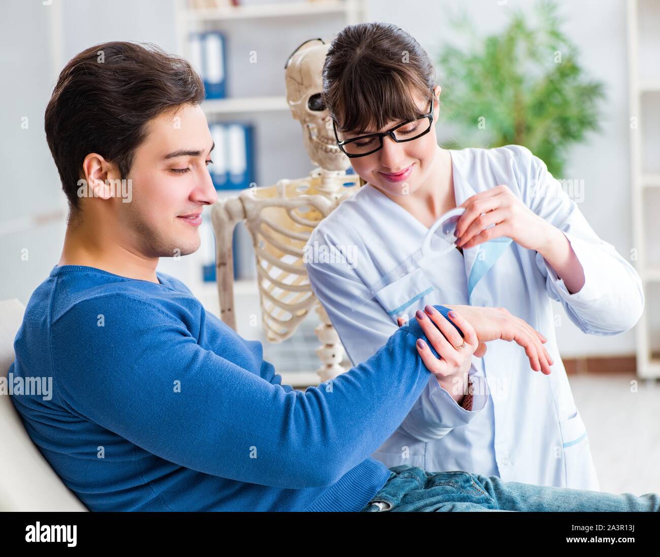 The doctor showing type of injury on skeleton to patient Stock Photo ...