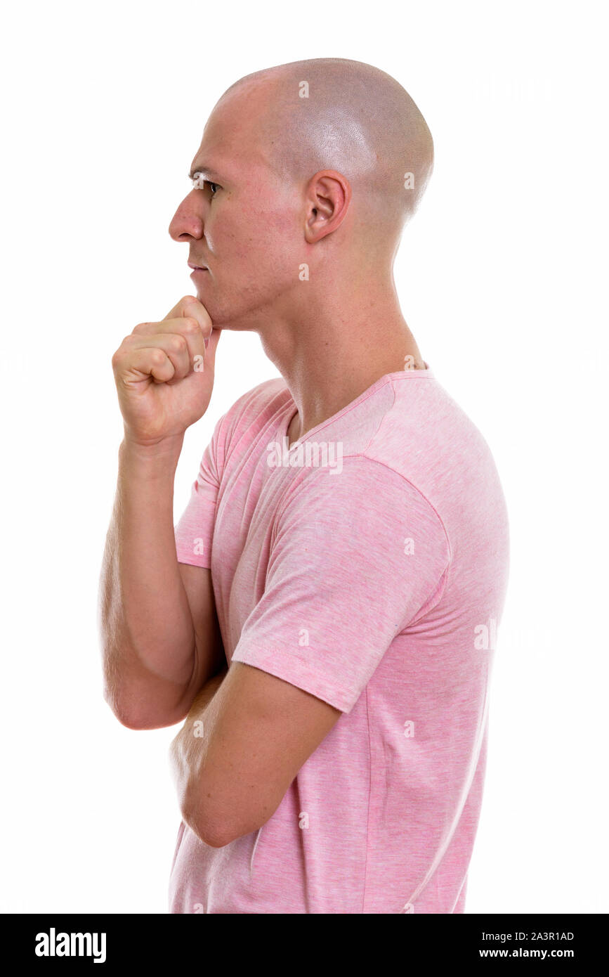 Profile view of young handsome bald man thinking Stock Photo - Alamy