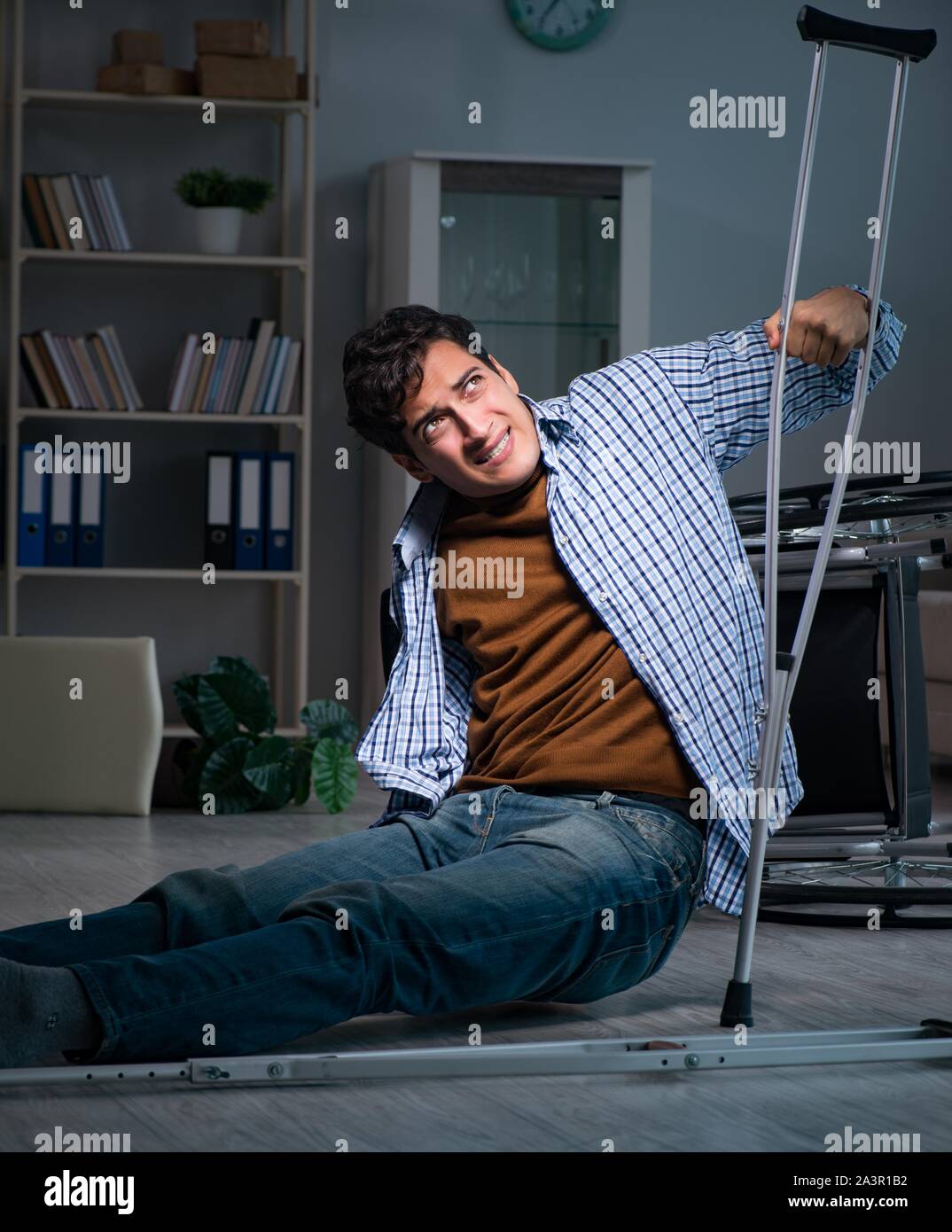 The man fell off wheelchair sitting on the floor Stock Photo - Alamy