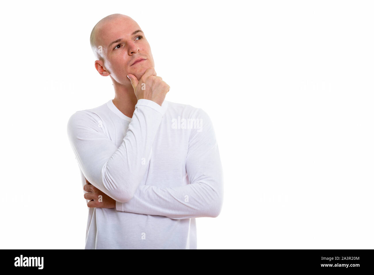 Studio shot of young handsome bald man thinking Stock Photo - Alamy