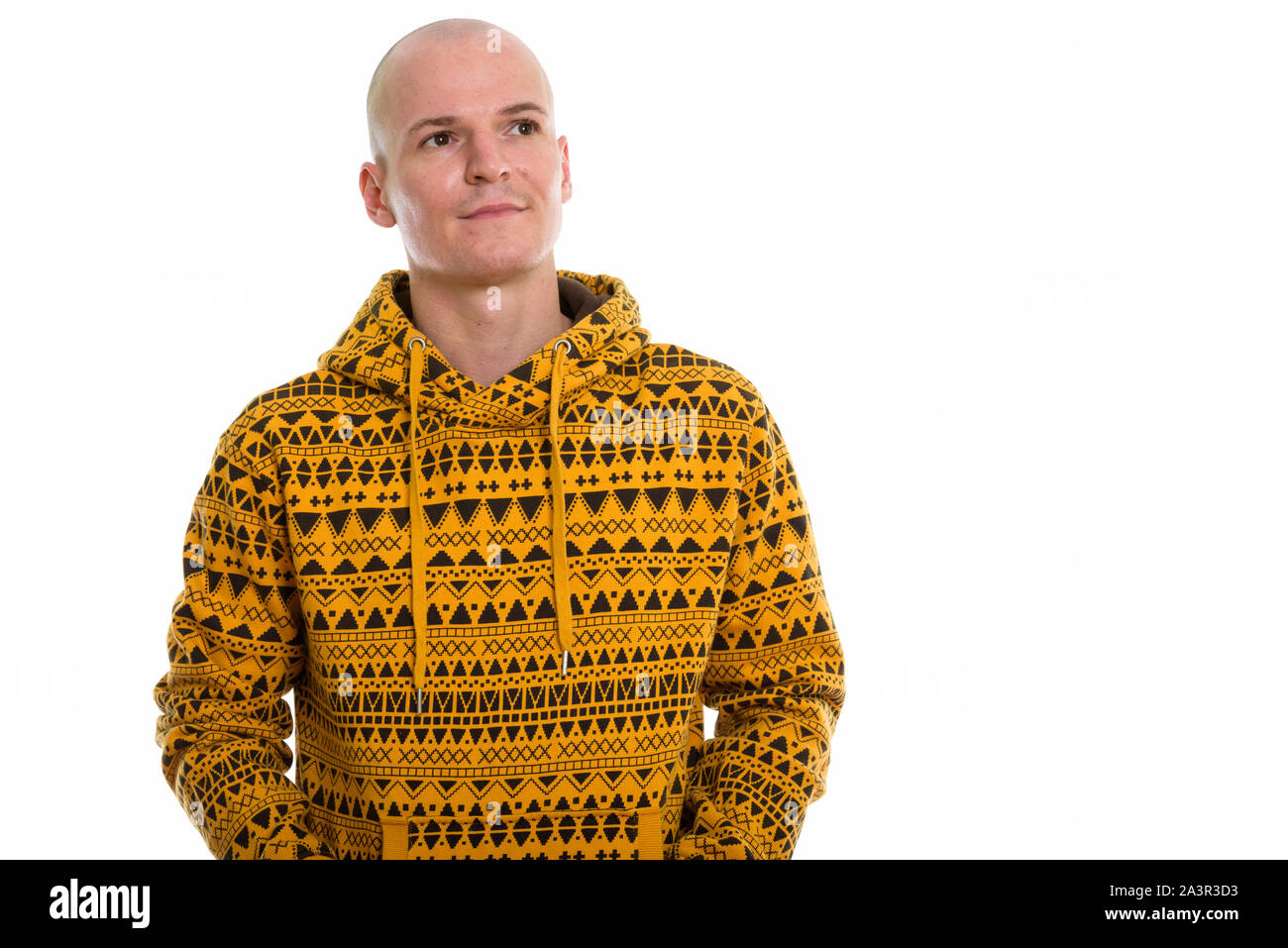 Studio shot of young handsome bald man thinking Stock Photo - Alamy
