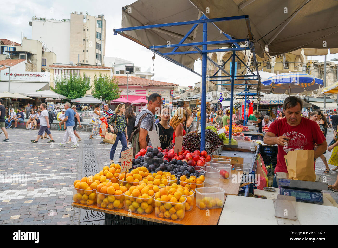 Athens Greece - July 15 2019; Street fruit vendor weighs bag of fruit ...