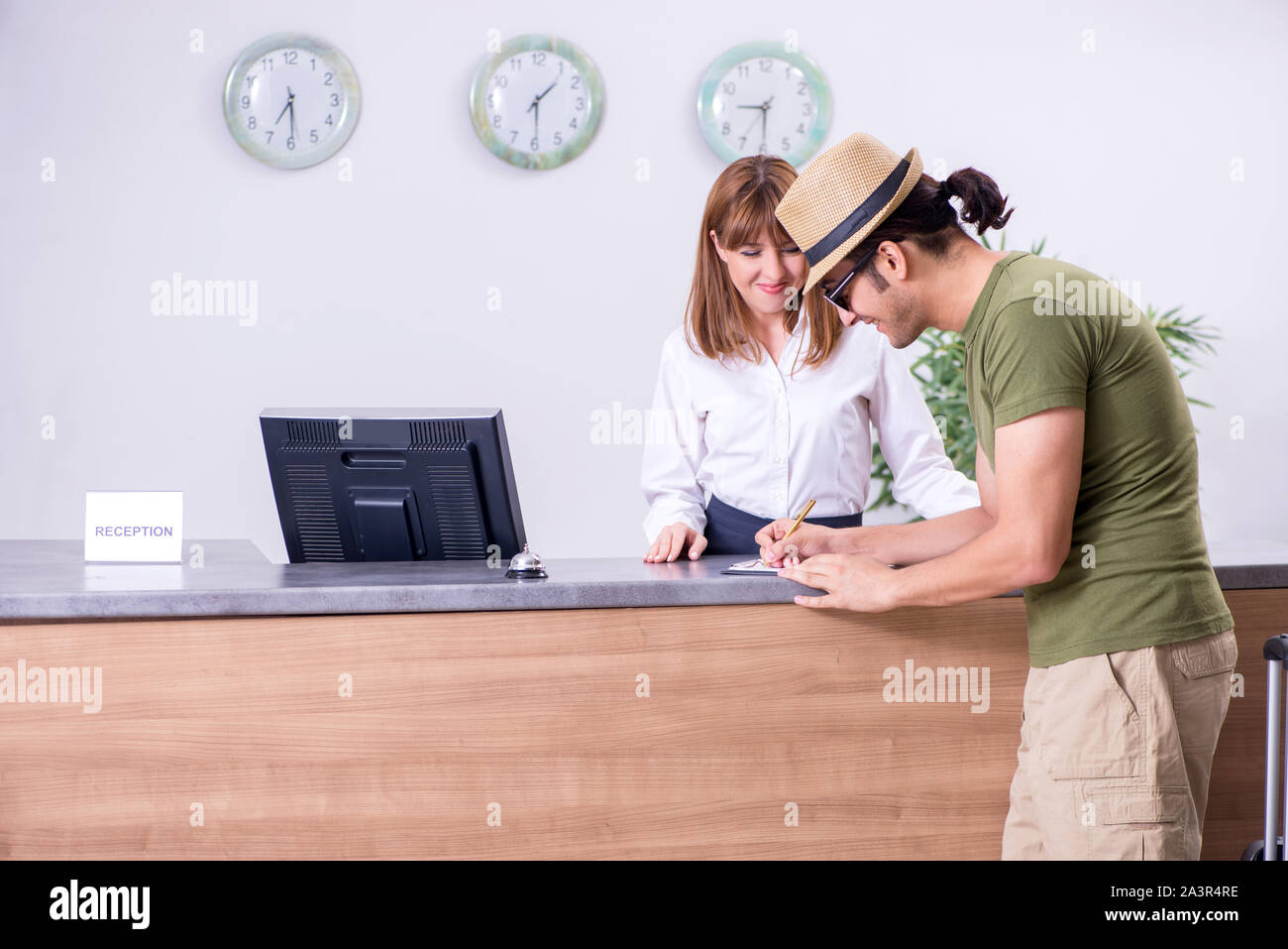 The young man at the hotel reception Stock Photo - Alamy